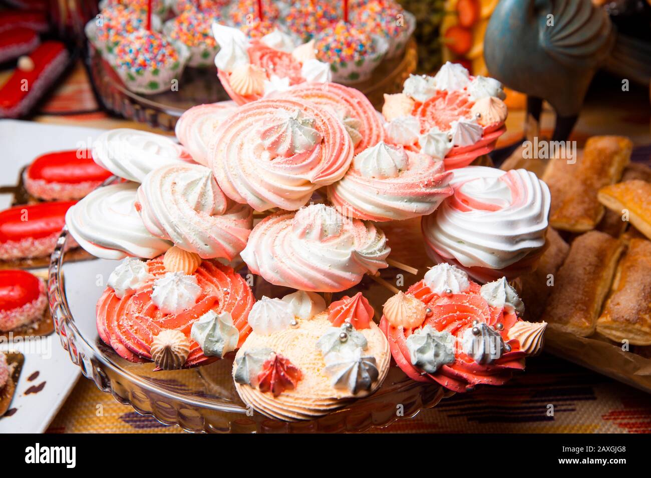 Crispy twisted meringues lie on a plate. Candy bar Stock Photo - Alamy