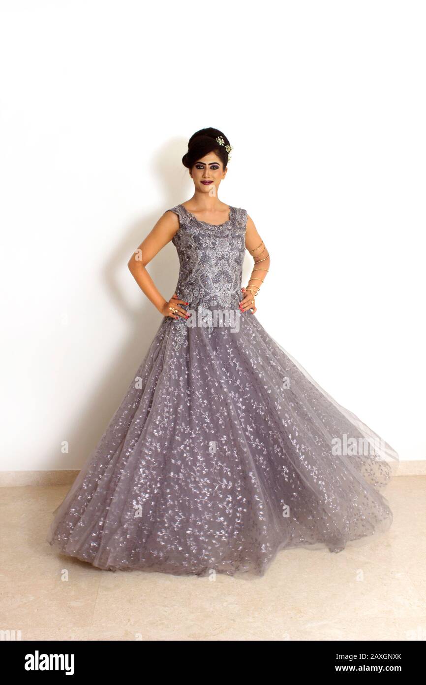 Portrait of young woman. Looking at camera. Full body view. Standing ...