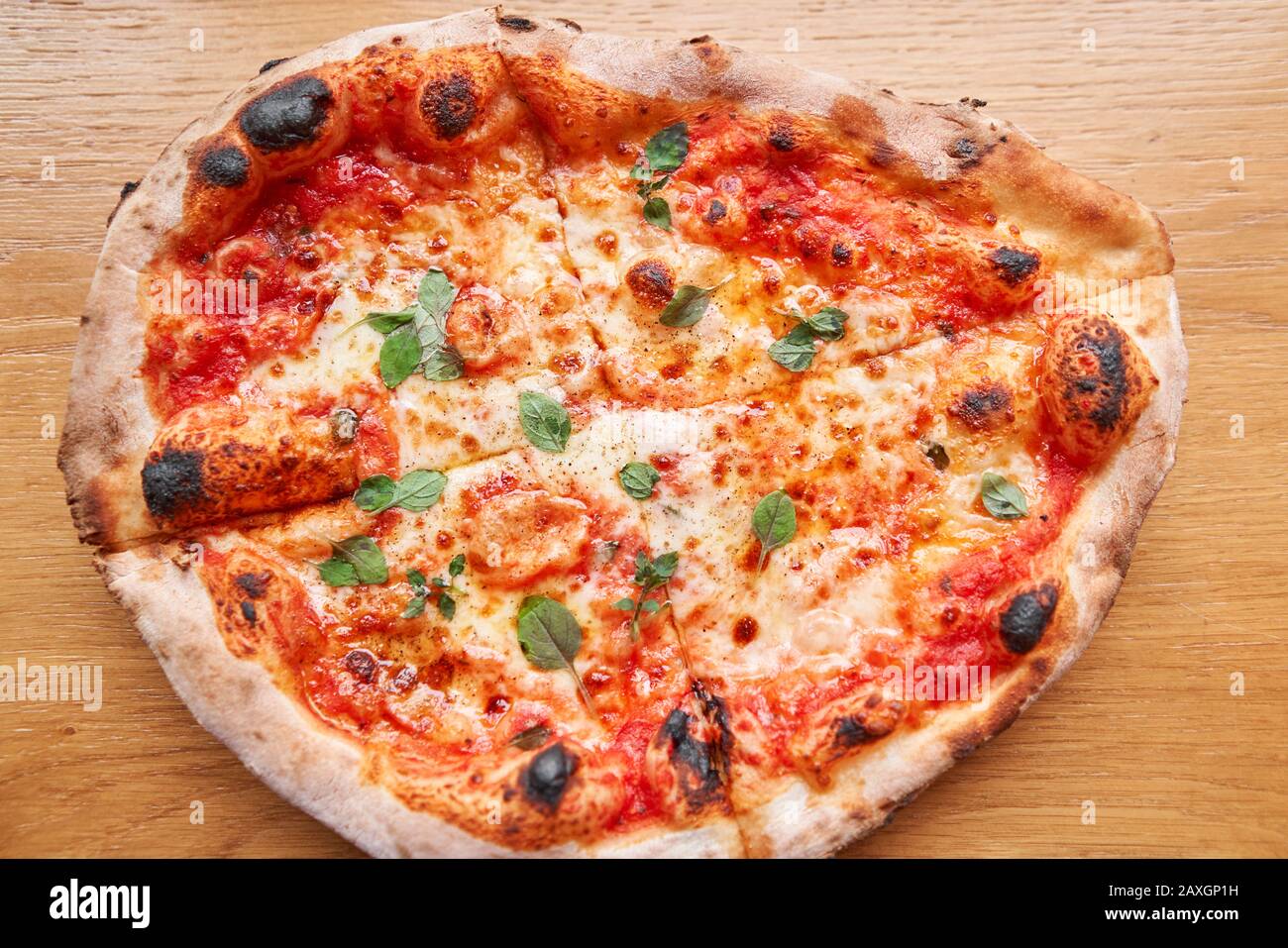 Pizza Margarita. Baked tasty margherita pizza in Traditional wood oven in Neapolitan restaurant ...