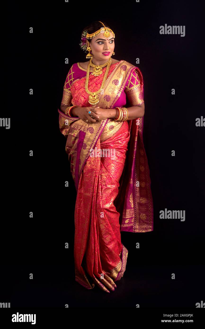Portrait of an young and beautiful Indian Bengali brunette woman in red ...