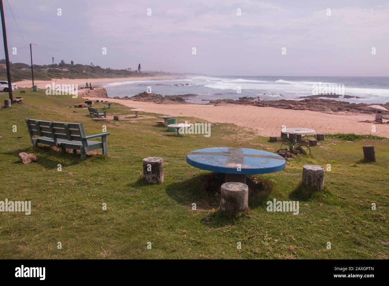 Bench and picnic table on grassed area at beach Stock Photo - Alamy