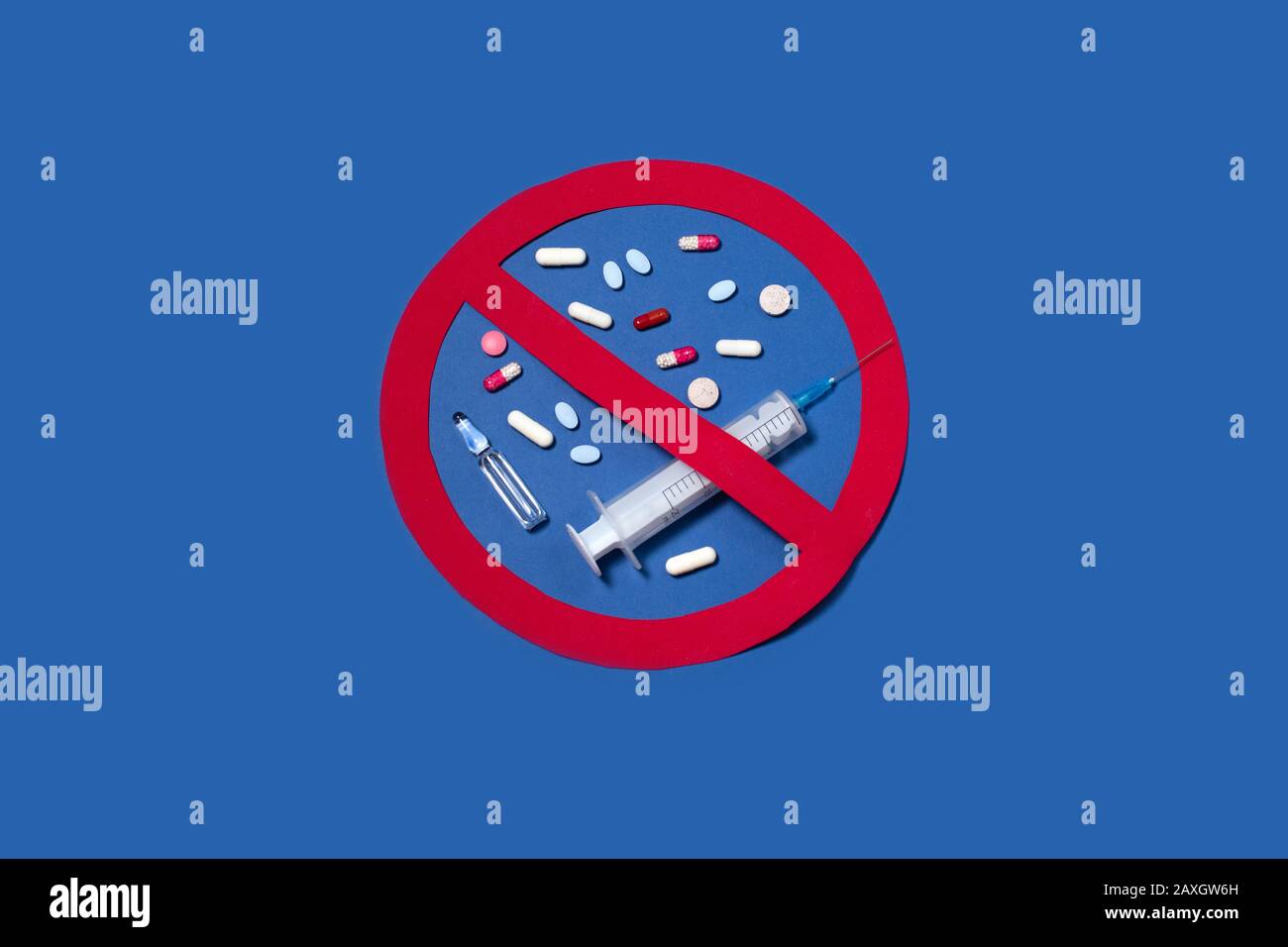 Red stop sign with Pills and syringe with on blue background. top view ...