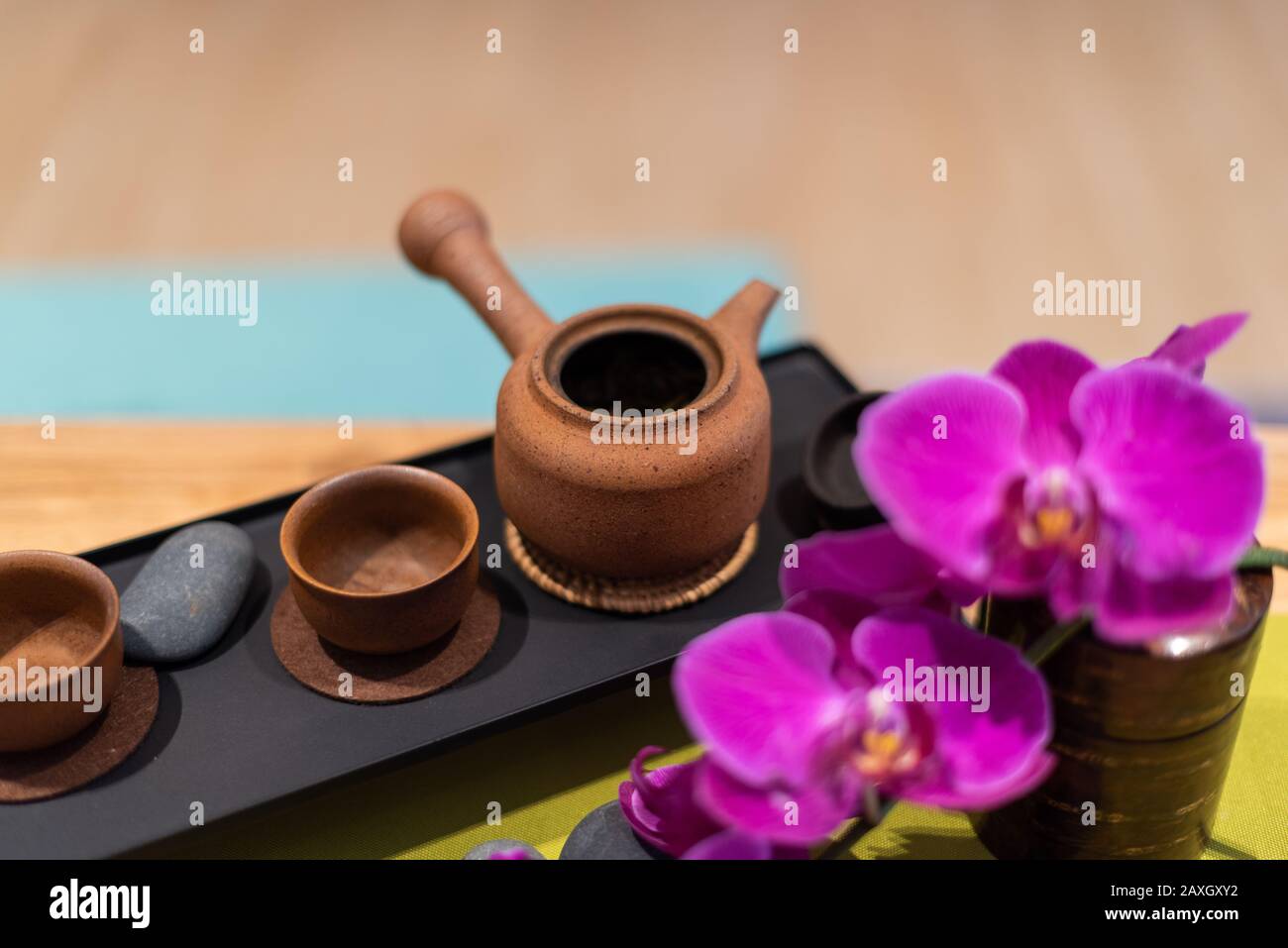 Traditional Chinese tea Set up with orchid and pebbles Stock Photo - Alamy