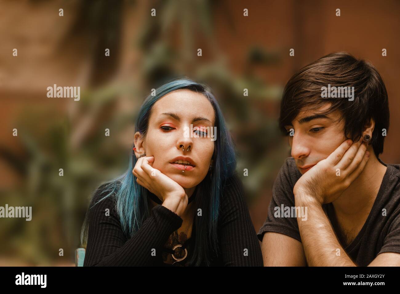 Bored friends thinking outdoors. Couple of teenagers after arguing ...