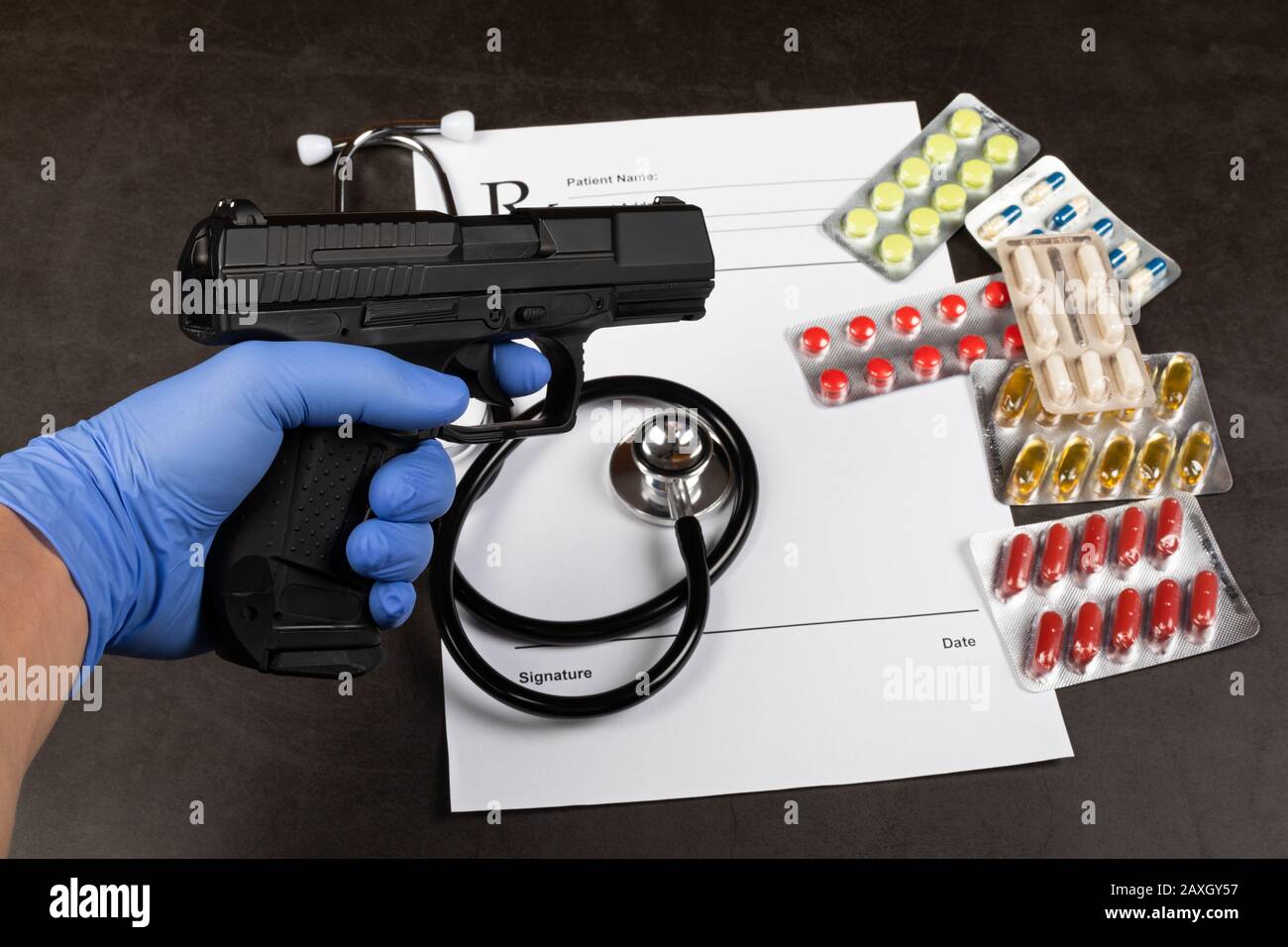 Doctor's hand pointing a gun over medical record Stock Photo - Alamy