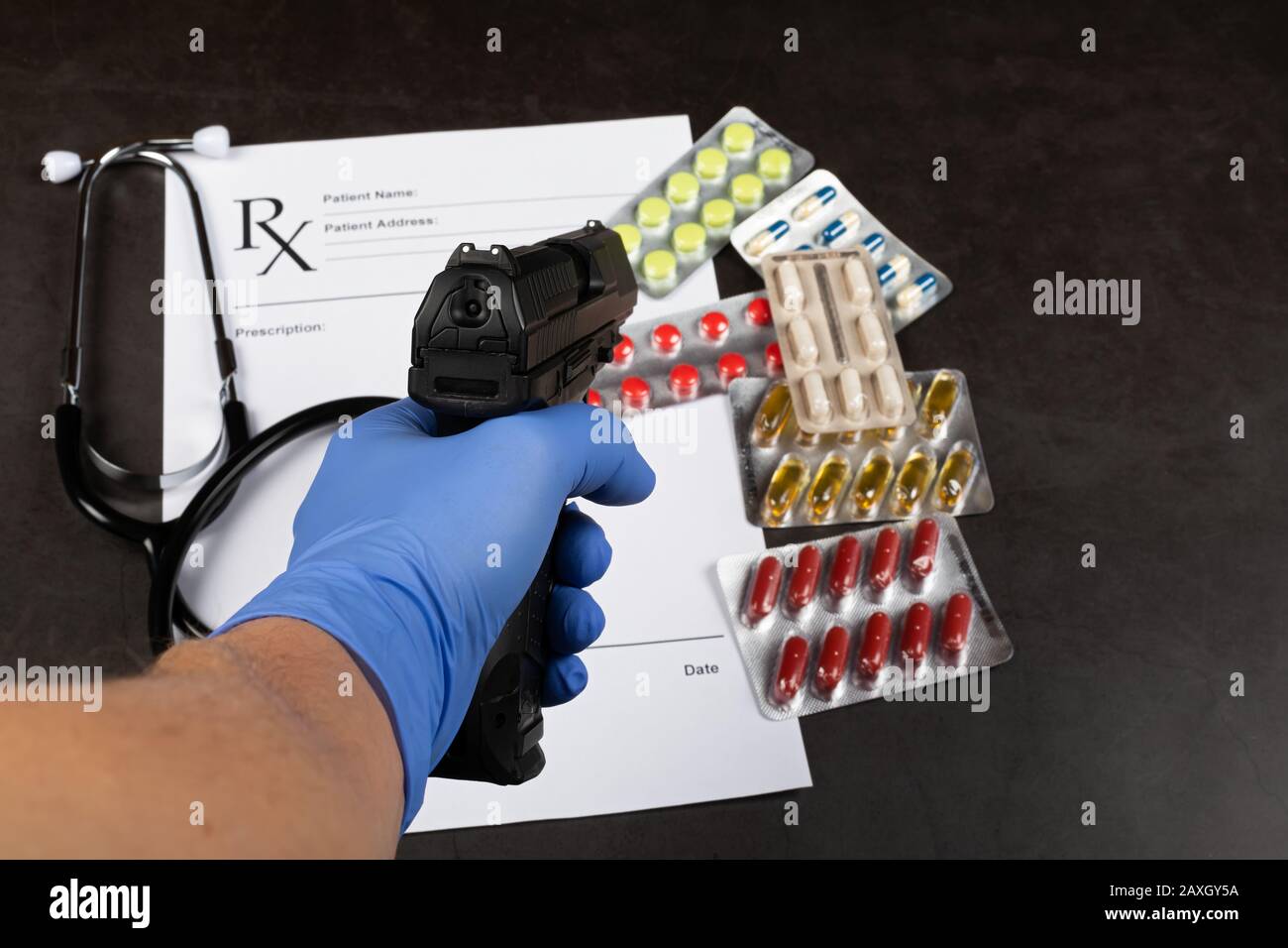 Doctor's hand pointing a gun over medical record Stock Photo - Alamy
