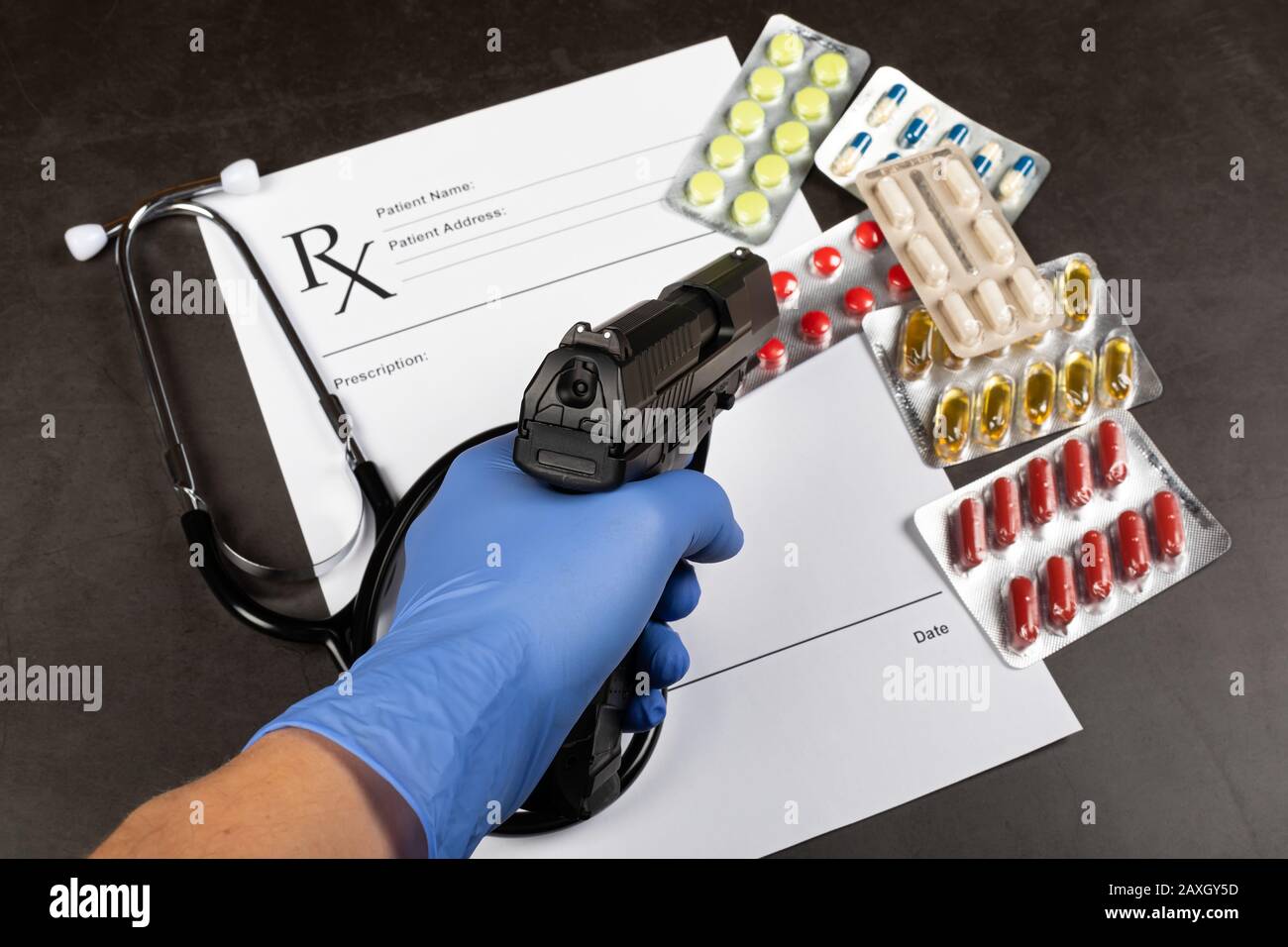 Doctor's hand pointing a gun over medical record Stock Photo - Alamy