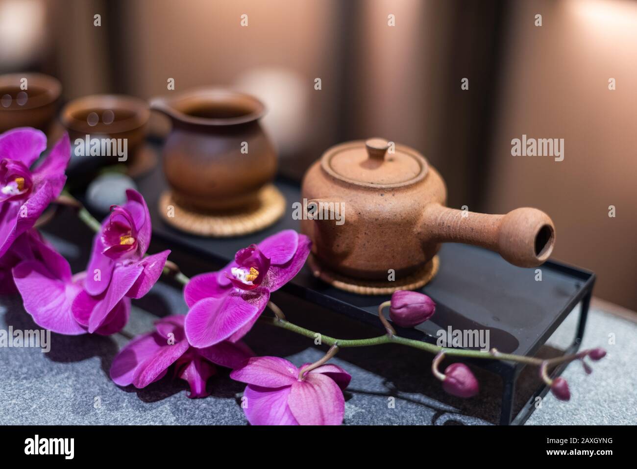 Traditional Chinese tea Set up with orchid and pebbles Stock Photo - Alamy