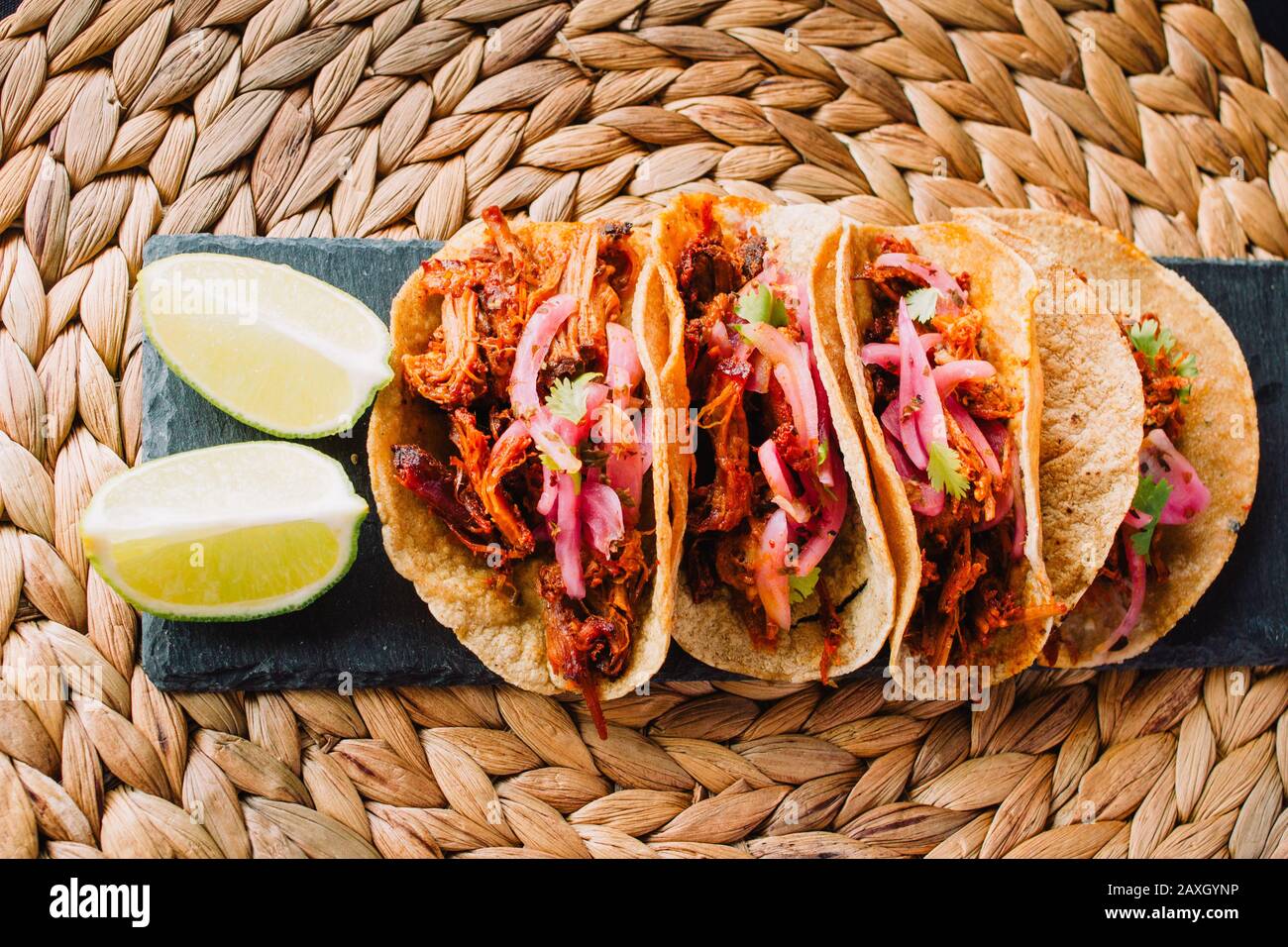 Mexican tacos filled with cochinita pibil on a rustic background ...