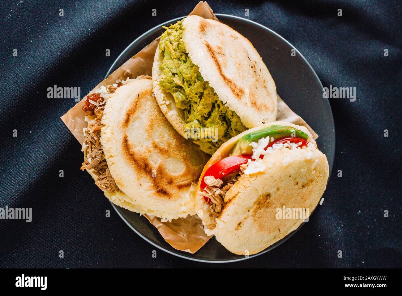 Venezuelan arepas on a flatlay view, black background Stock Photo - Alamy