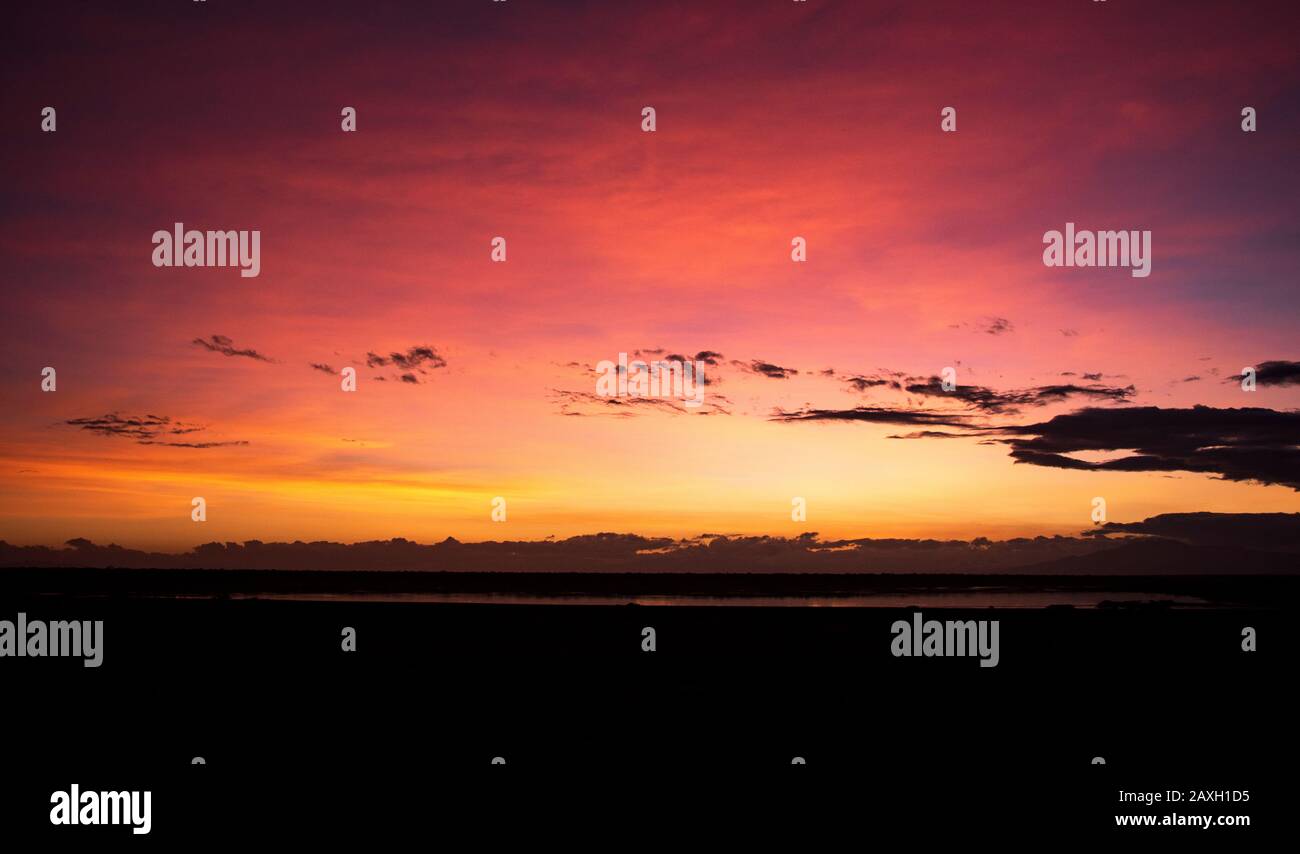 The changing colors of sunrise over lake Ndutu Stock Photo - Alamy