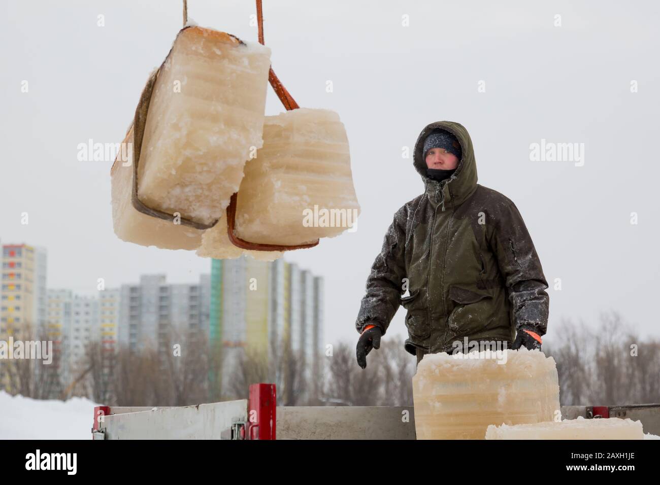 Slinger works with a truck crane on ice Stock Photo - Alamy
