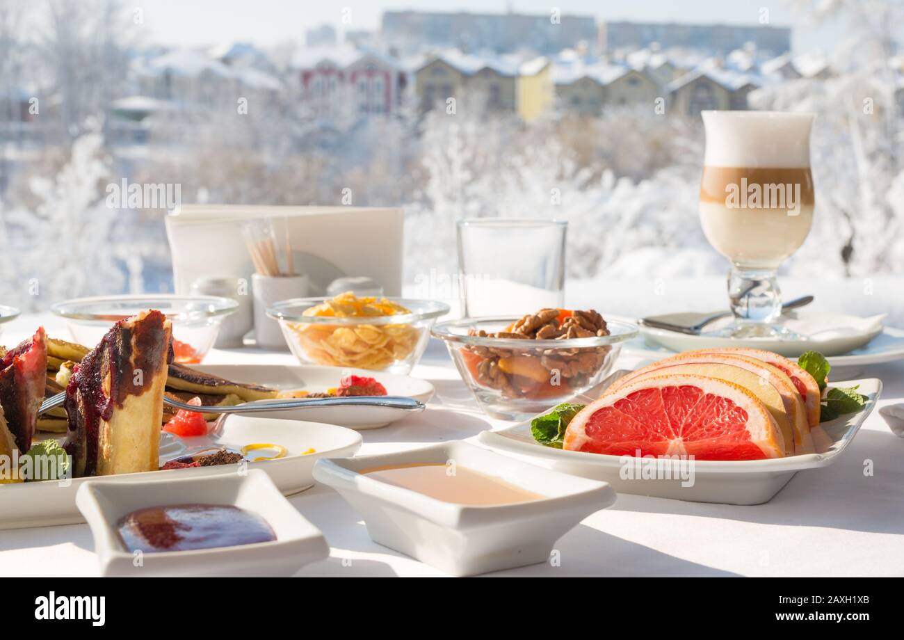 Breakfast at the restaurant in the snowy winter outdoors Stock Photo ...