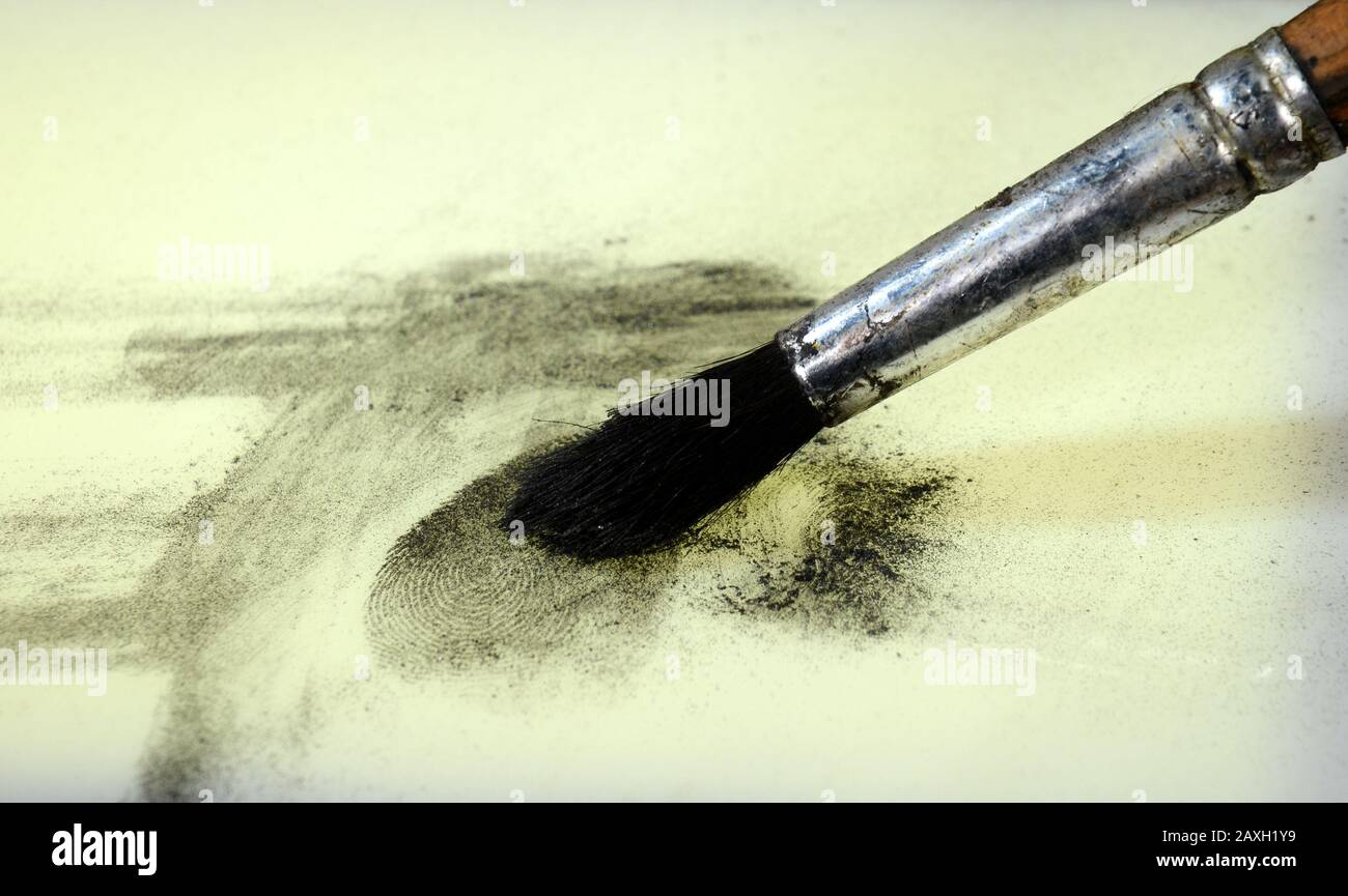 Fingerprint being "dusted" with a prush and some very fine grained ...