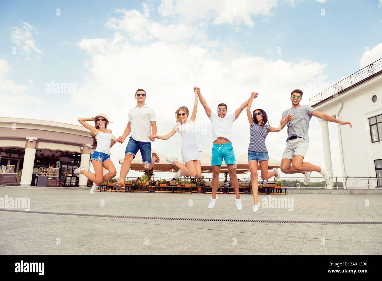 joyful success six friends having fun, achieving goal and jumping Stock ...