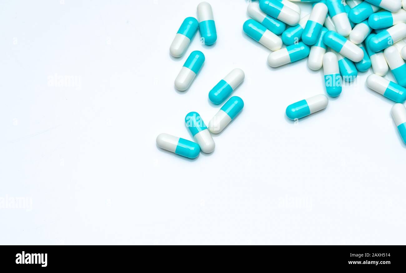 Blue-white capsule pills on white background. Antibiotic drug ...