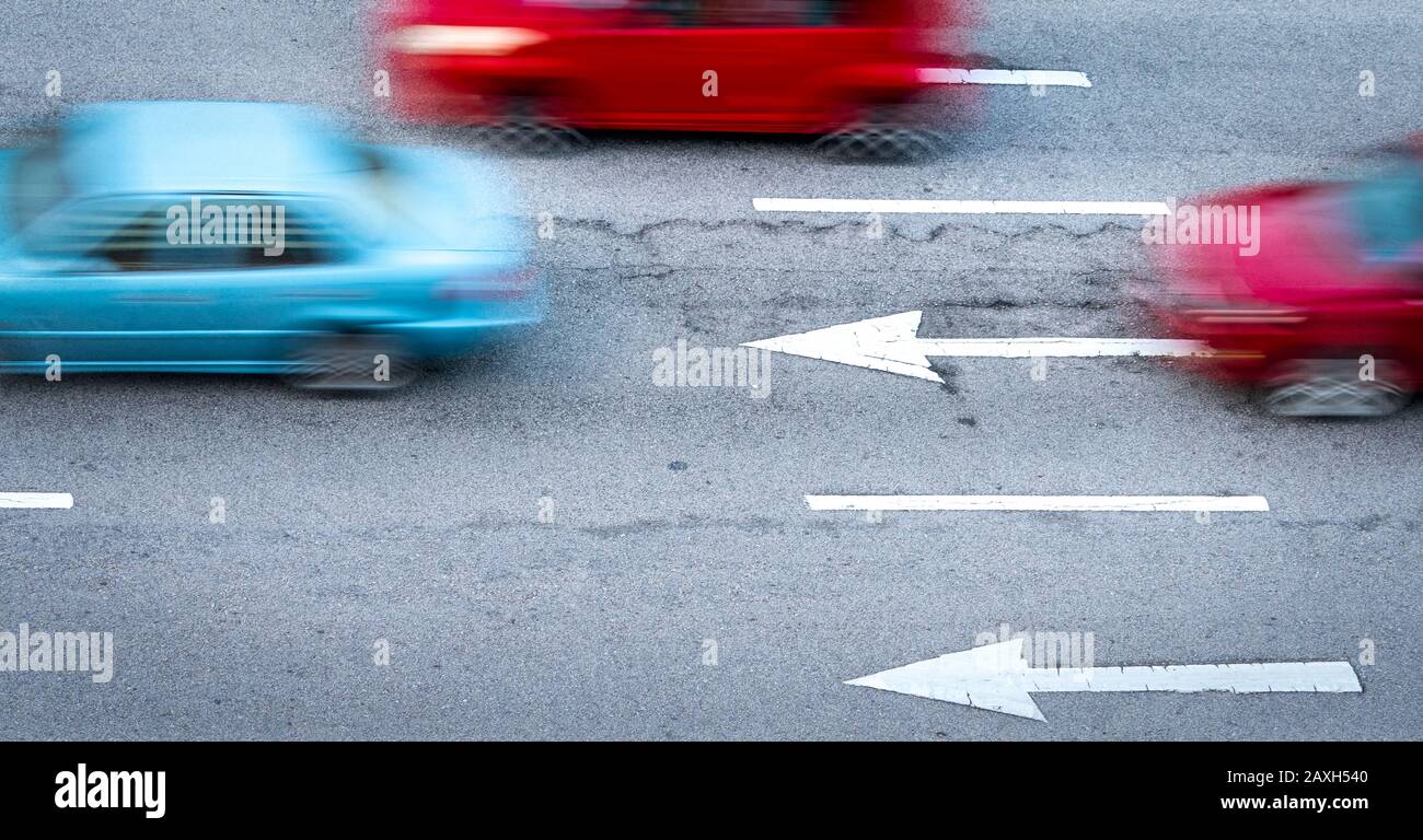 Red and blue car fast moving on asphalt road in the city. Blurred ...