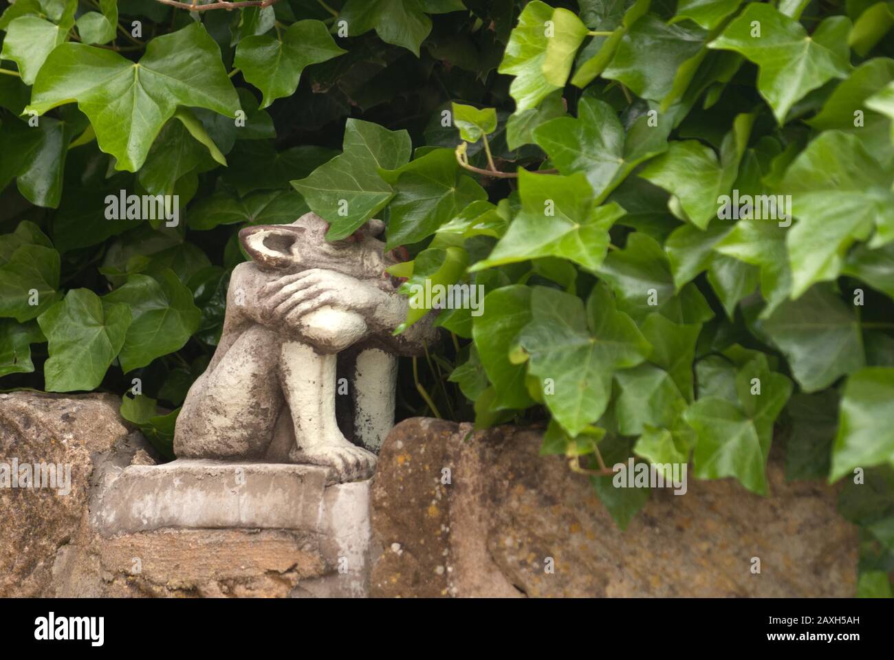Statue of strange creature on a wall, Great Ayton, North Yorkshire ...