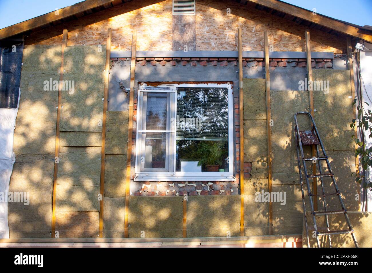 warming the walls of a stone house with a stone wool heater. Ecological ...