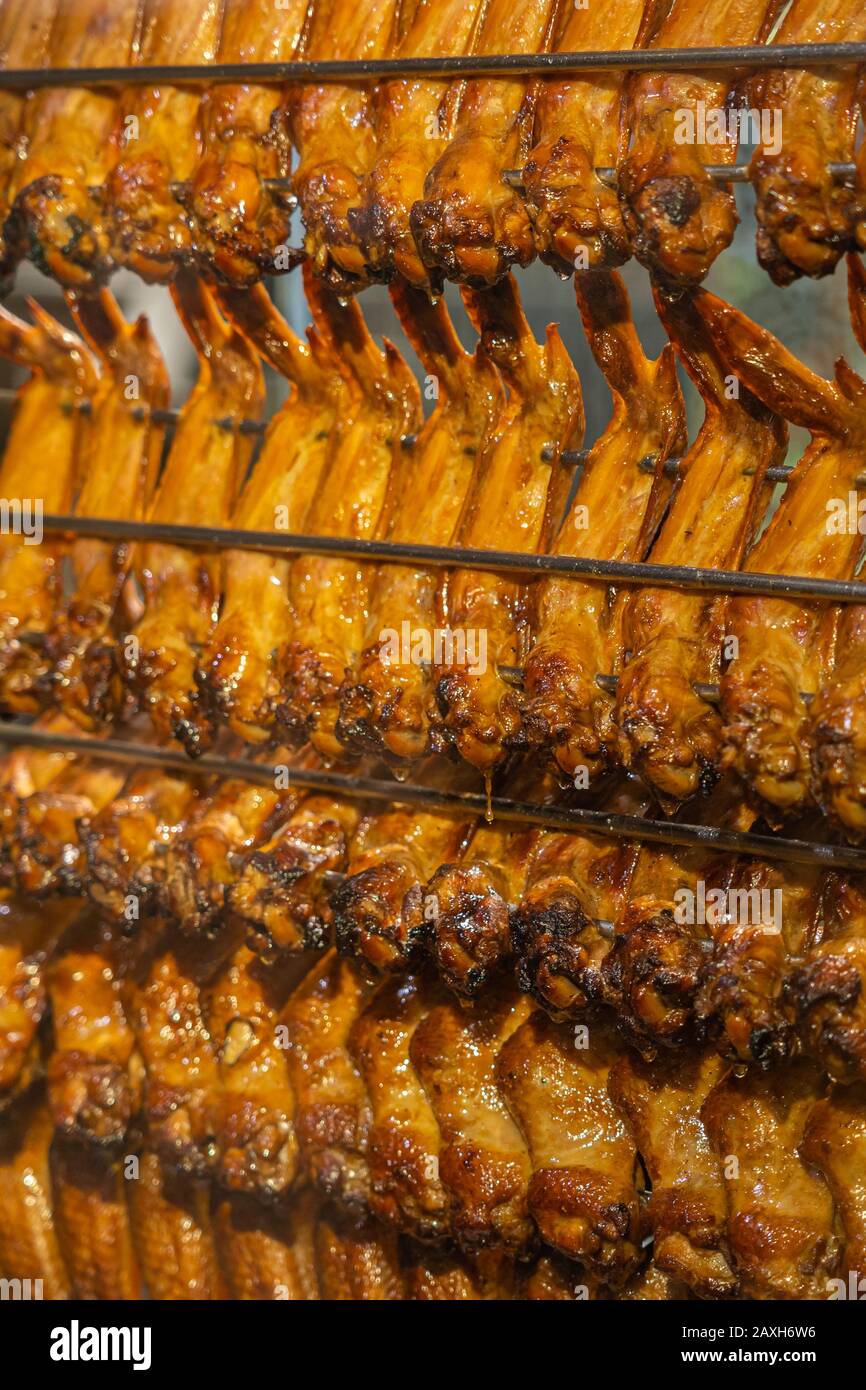 Delicious roasted chicken wings in rows on metal skewers Stock Photo ...