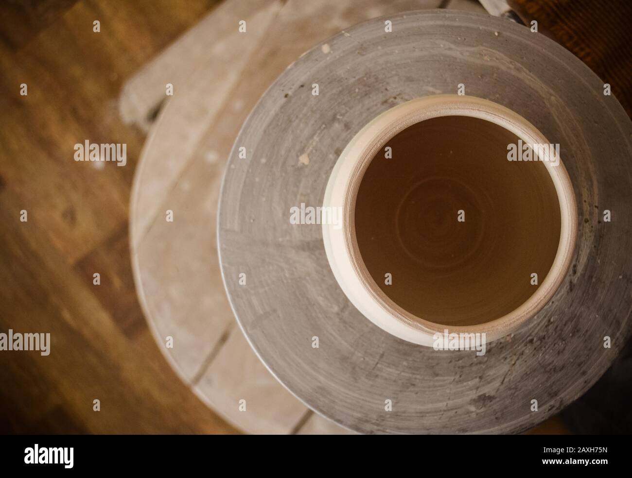 Clay pot on top of a potter's wheel. Abstract top view of a ceramic pot ...