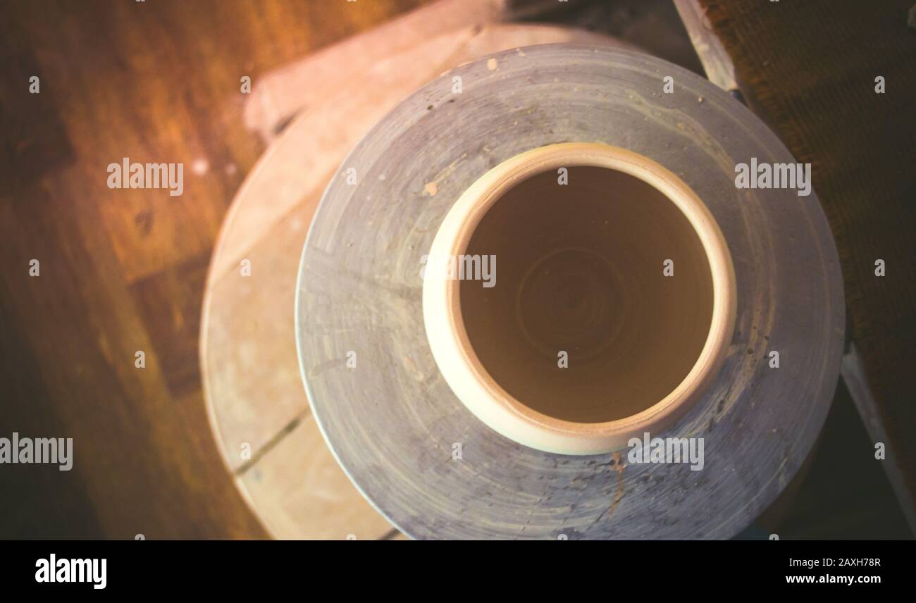 Clay pot on top of a potter's wheel. Abstract top view of a ceramic pot ...