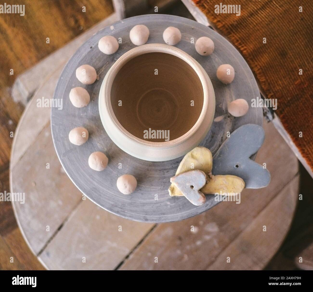 Clay pot on top of a potter's wheel. Abstract top view of a ceramic pot ...
