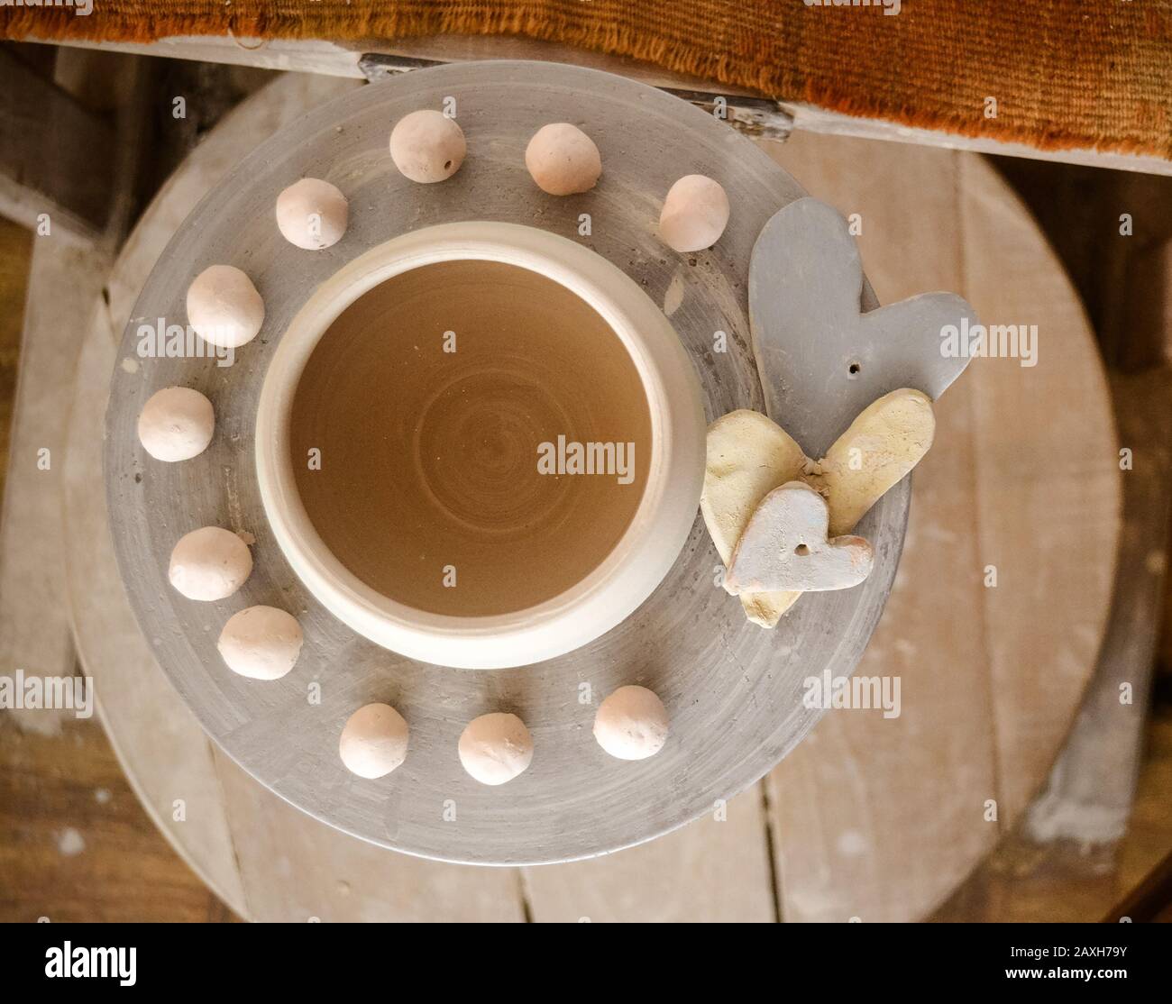 Clay pot on top of a potter's wheel. Abstract top view of a ceramic pot ...