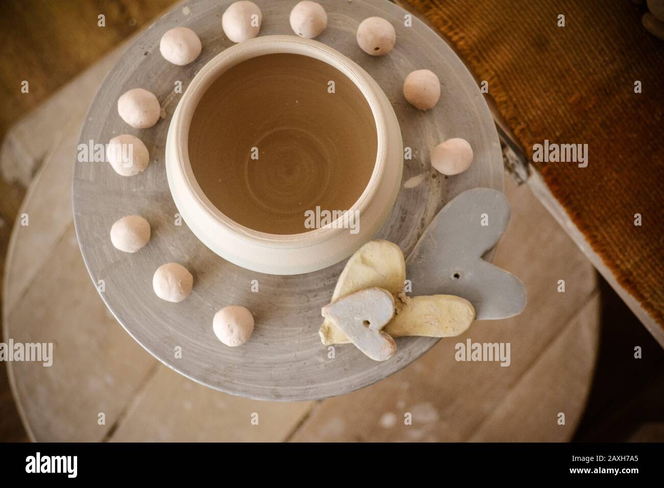 Clay pot on top of a potter's wheel. Abstract top view of a ceramic pot ...