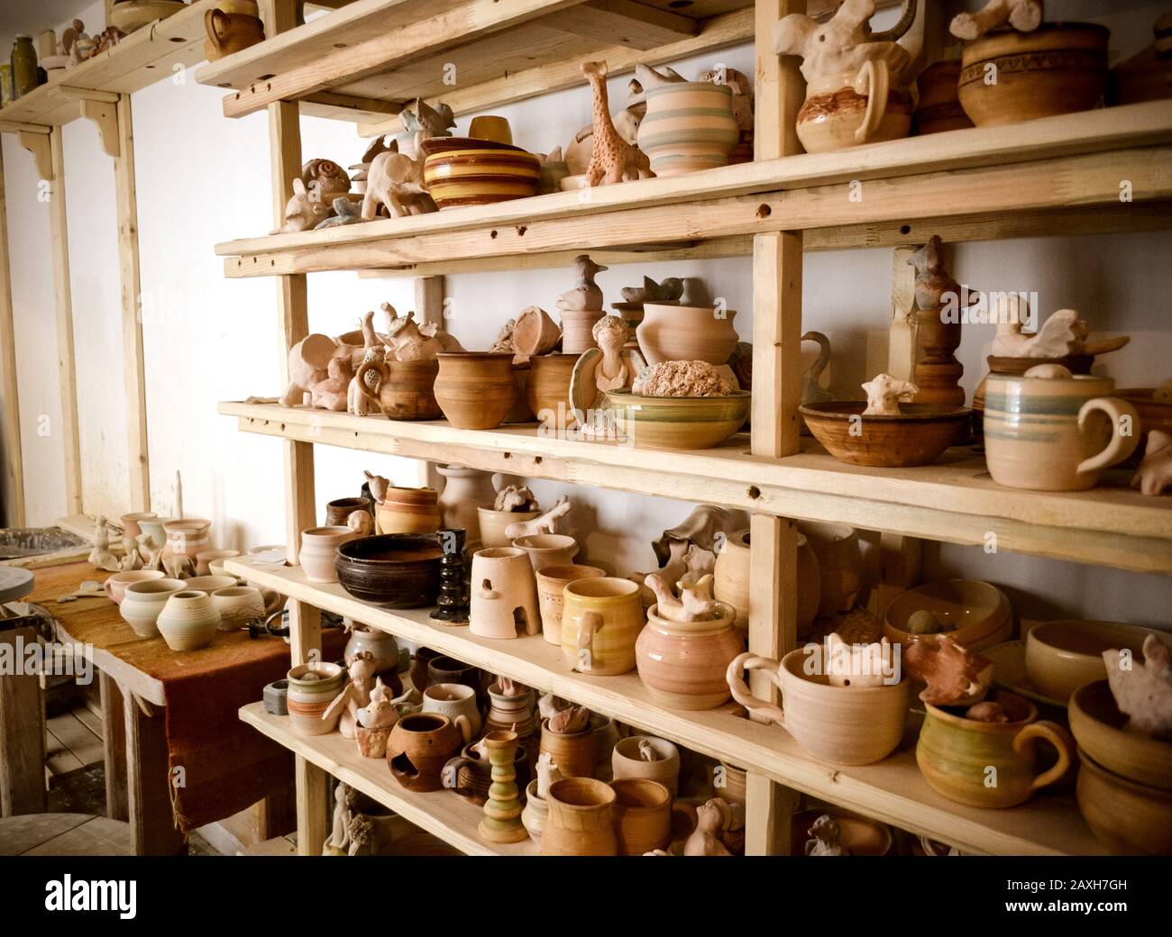 Wooden racks in a pottery workshop in which there are pottery, many ...