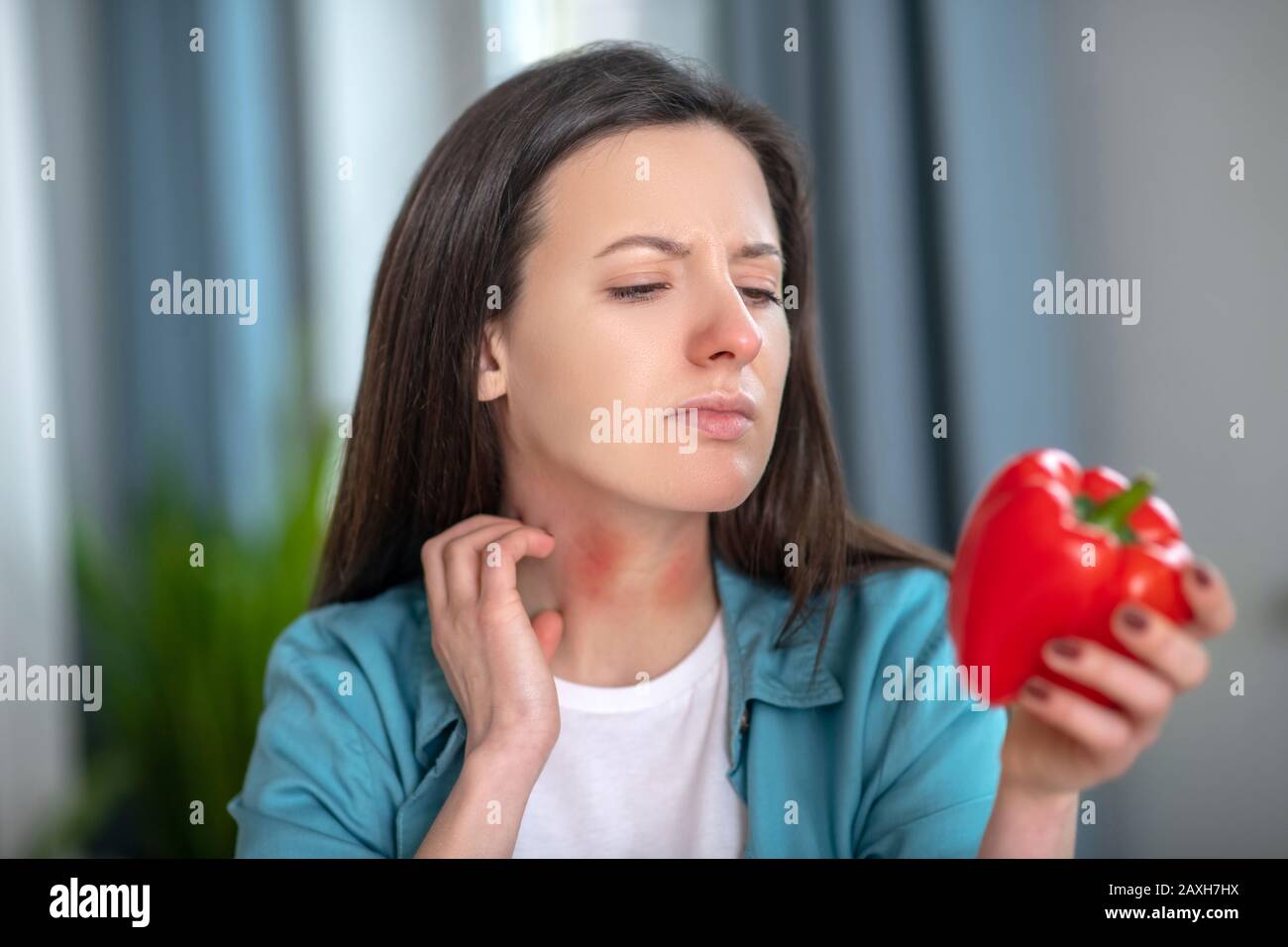Woman having an allergy for a sweet pepper Stock Photo - Alamy