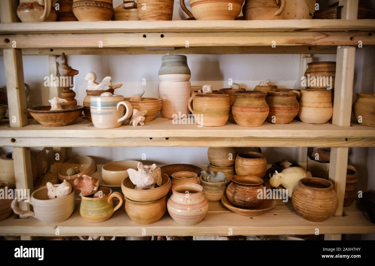 Wooden racks in a pottery workshop in which there are pottery, many ...