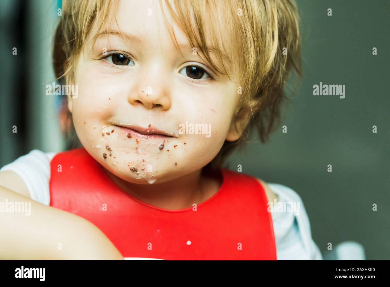 A portrait adorable child eating chocolate sponge cake Stock Photo - Alamy