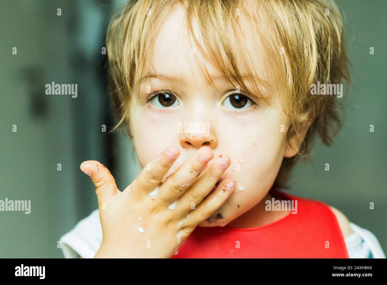 A portrait adorable child eating chocolate sponge cake Stock Photo - Alamy