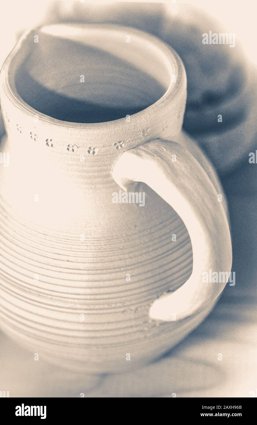Old vintage photo. Jug of clay. Pitcher made of white clay. Before ...