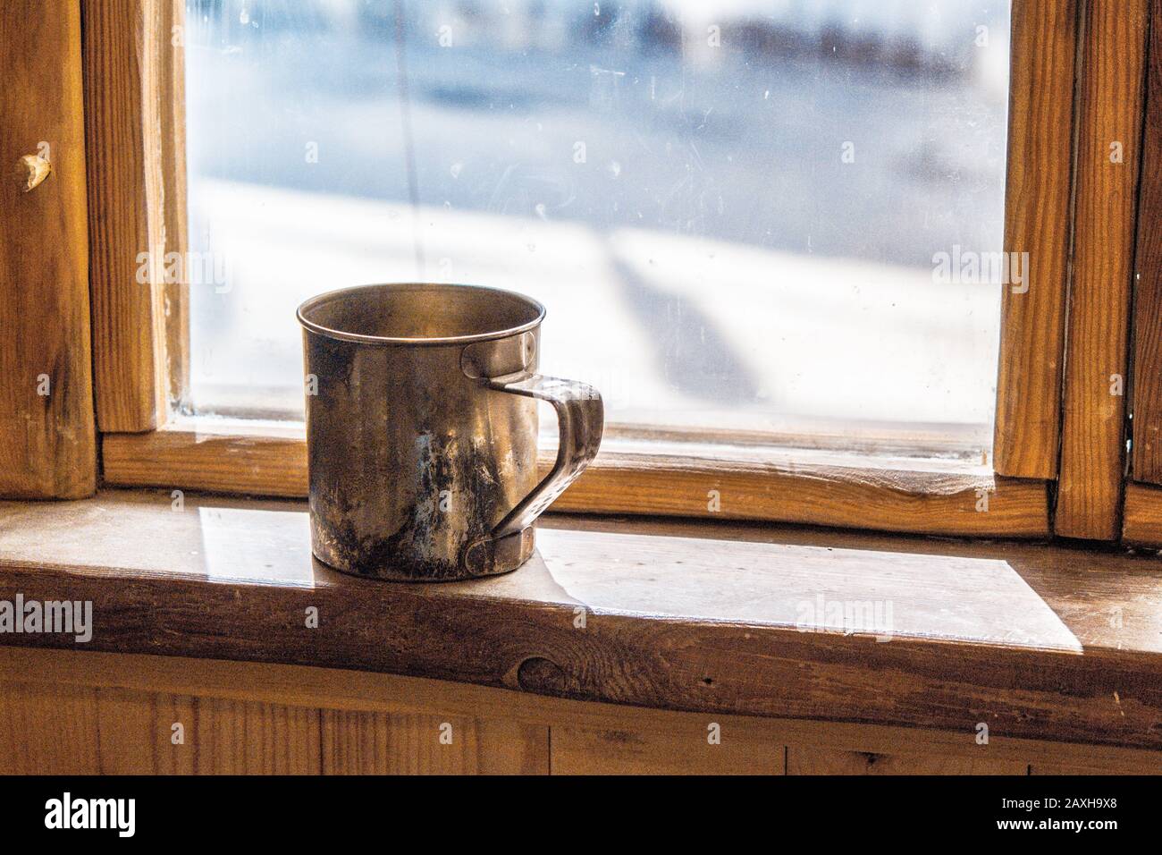 Old metal mug stands on a wooden window sill Stock Photo - Alamy