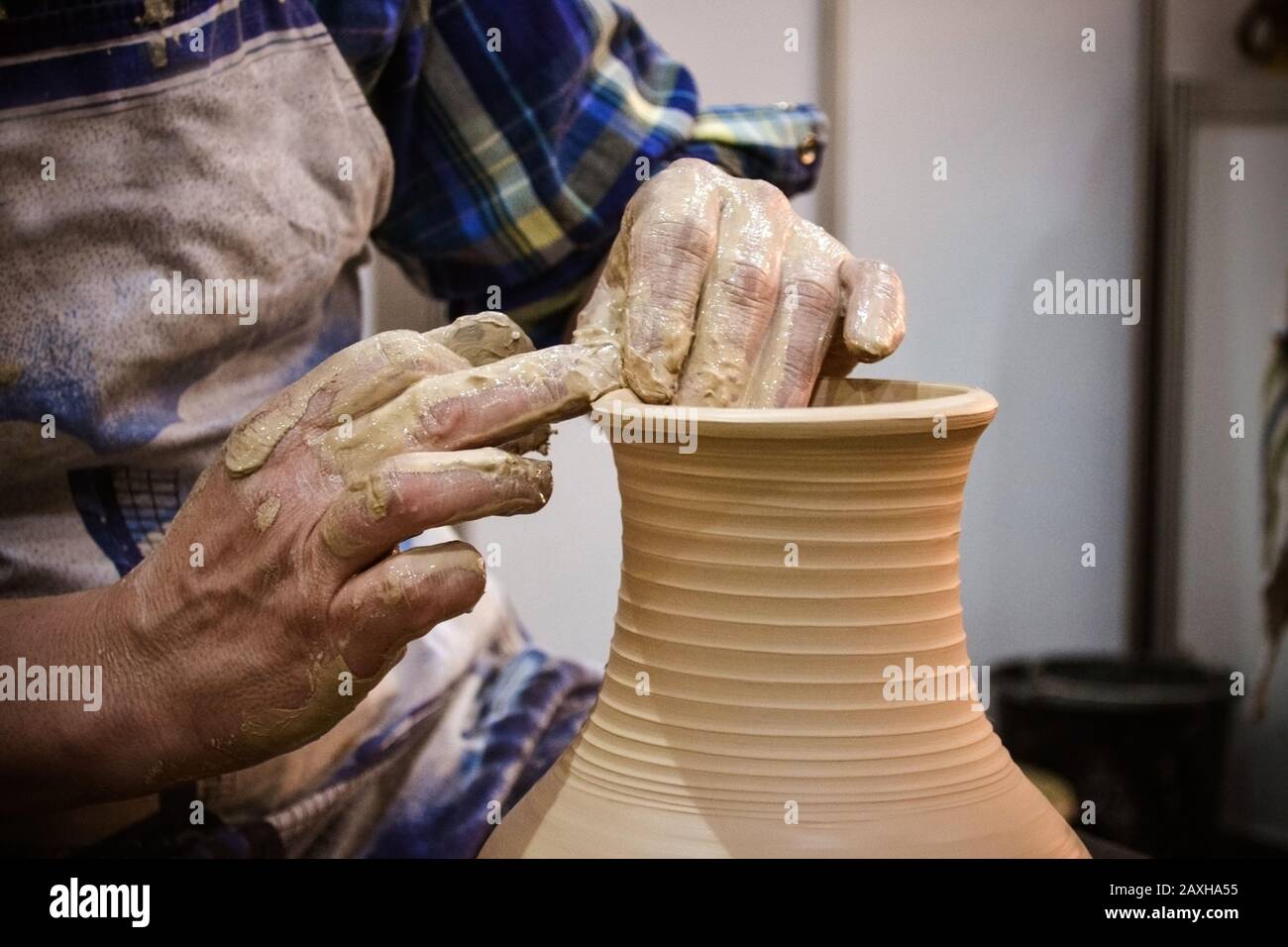 The potter molds clay jug pot closeup. Workshop on sculpt white clay ...