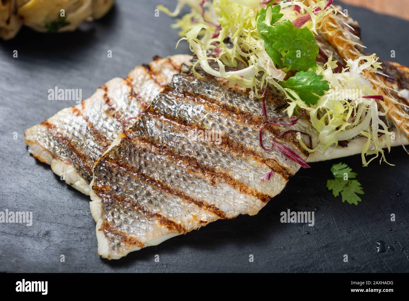 Fine Dining Fish dish on slate Stock Photo - Alamy