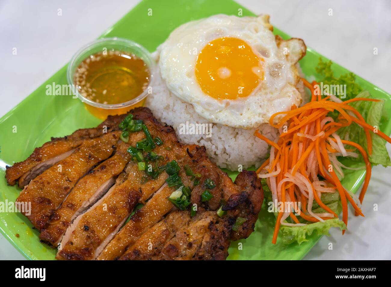 Roasted chicken rice served with sunny egg and pickles Stock Photo - Alamy