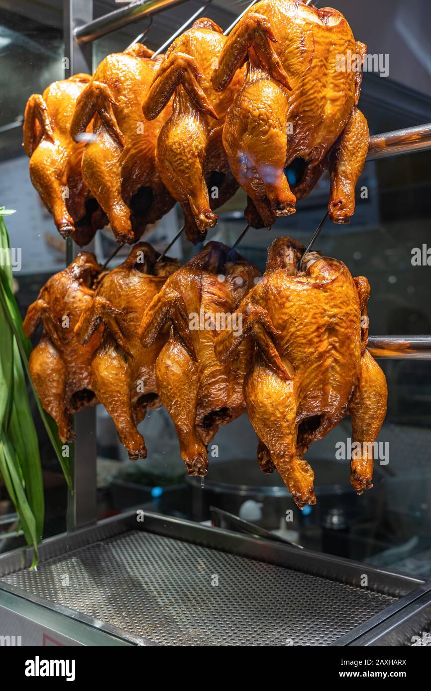 Whole roasted spicy chickens hanging in Chinese restaurant's showcase ...