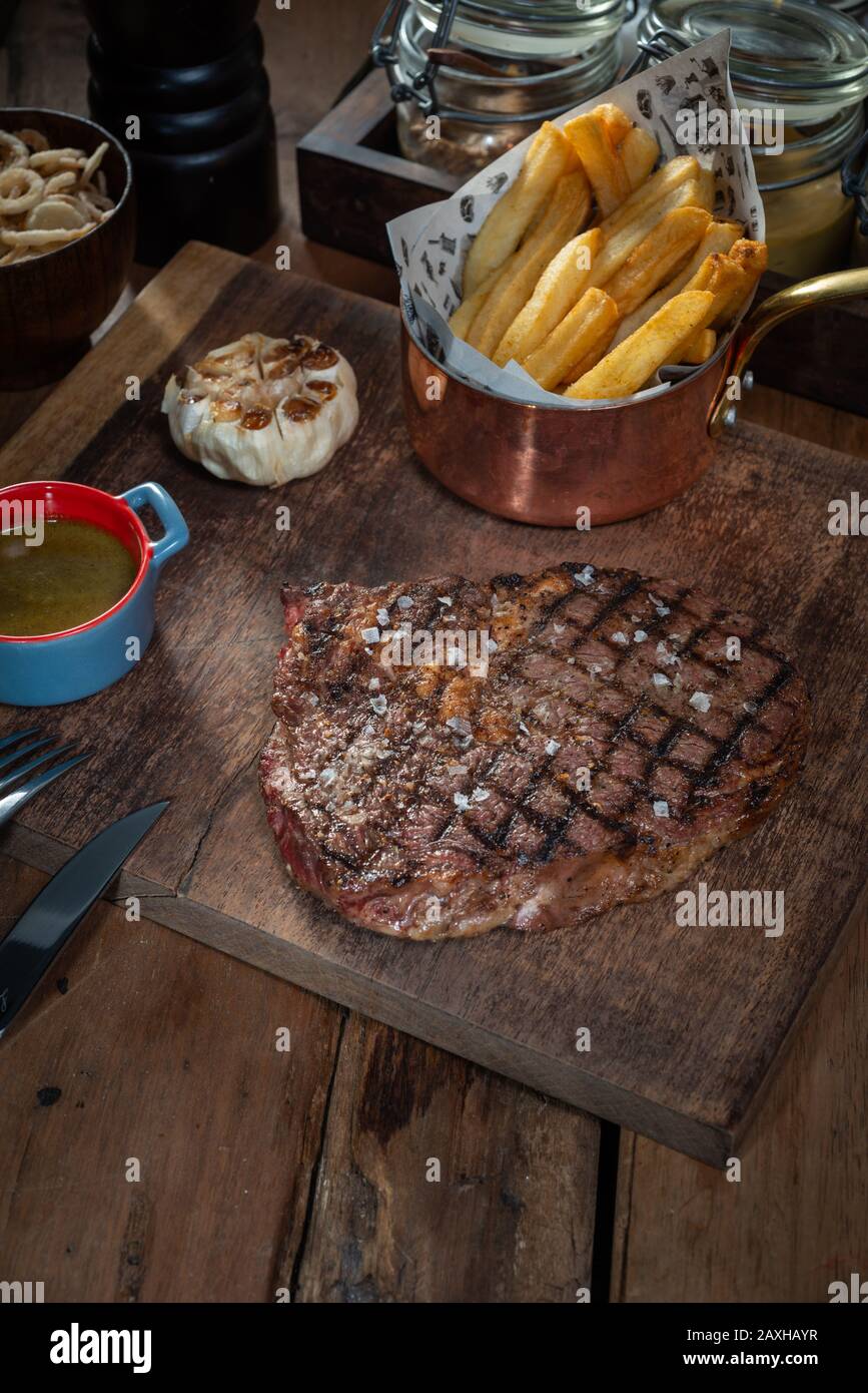 Steak on rustic cutting board Stock Photo - Alamy