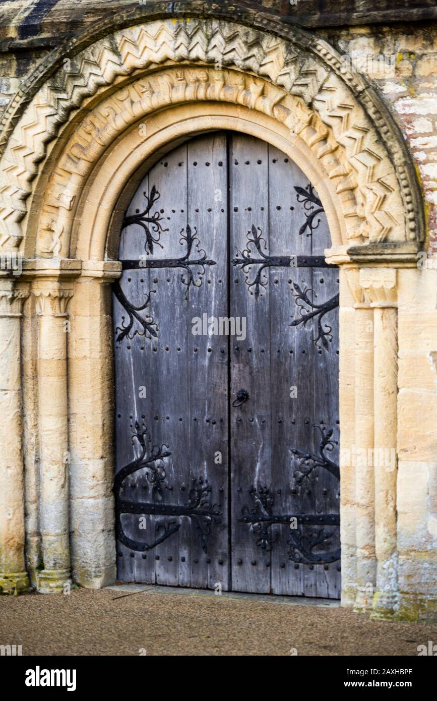 Wrought iron hinges and elaborate carved arched doorway in Burford ...