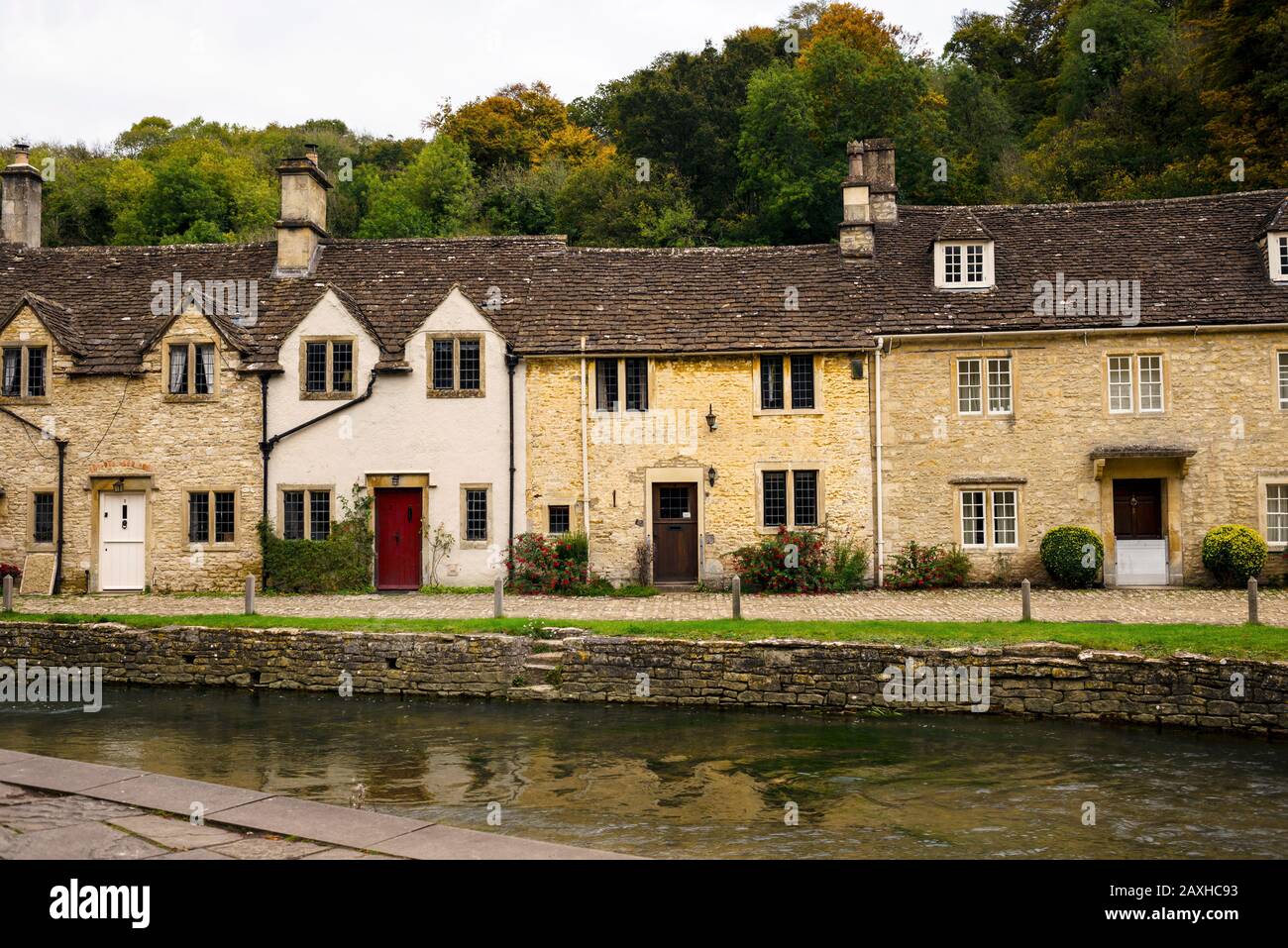 Village of Castle Combe, England stone buildings along the By River ...