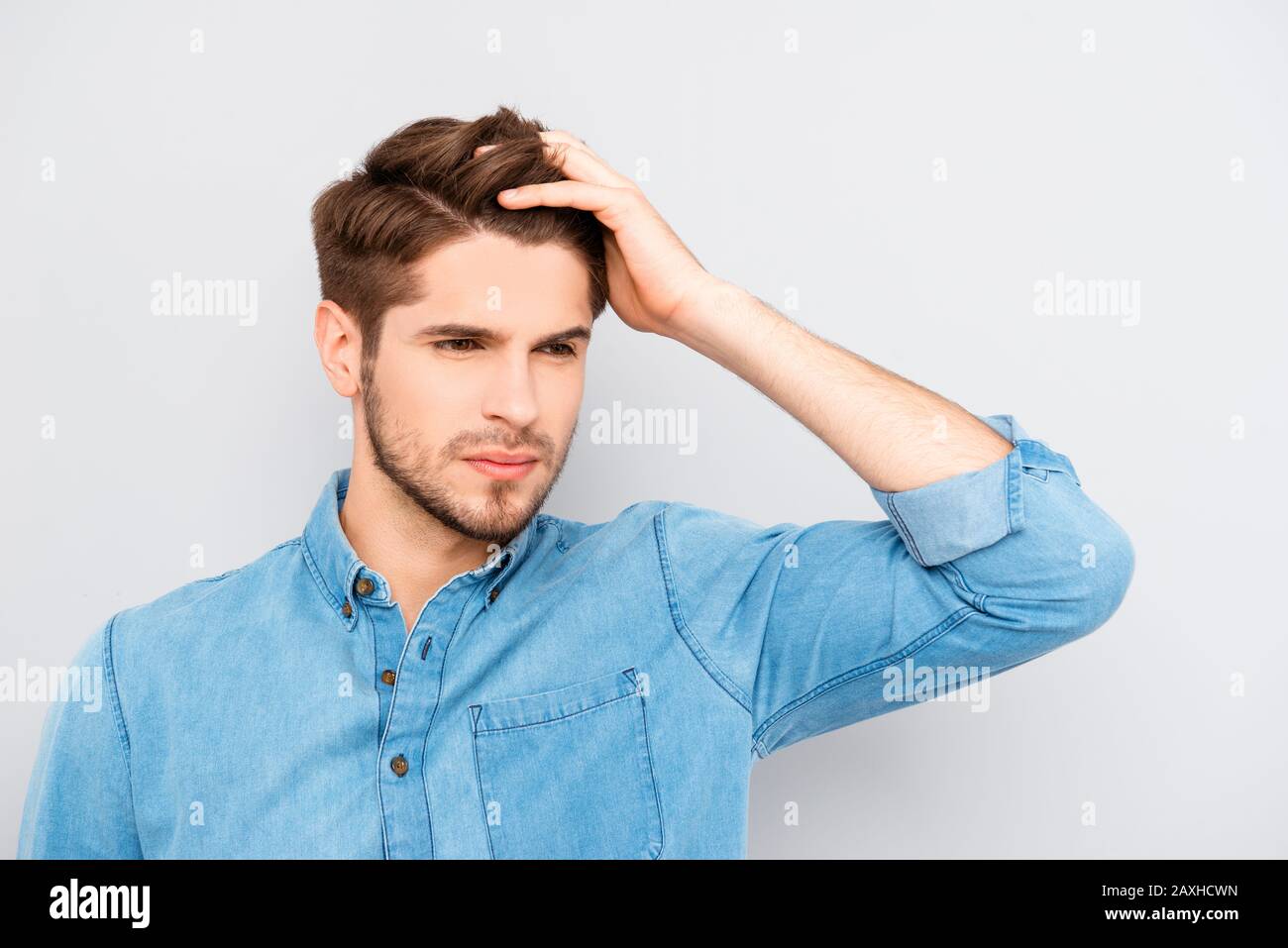 Portrait of handsome stylish young man touching his hair Stock Photo ...