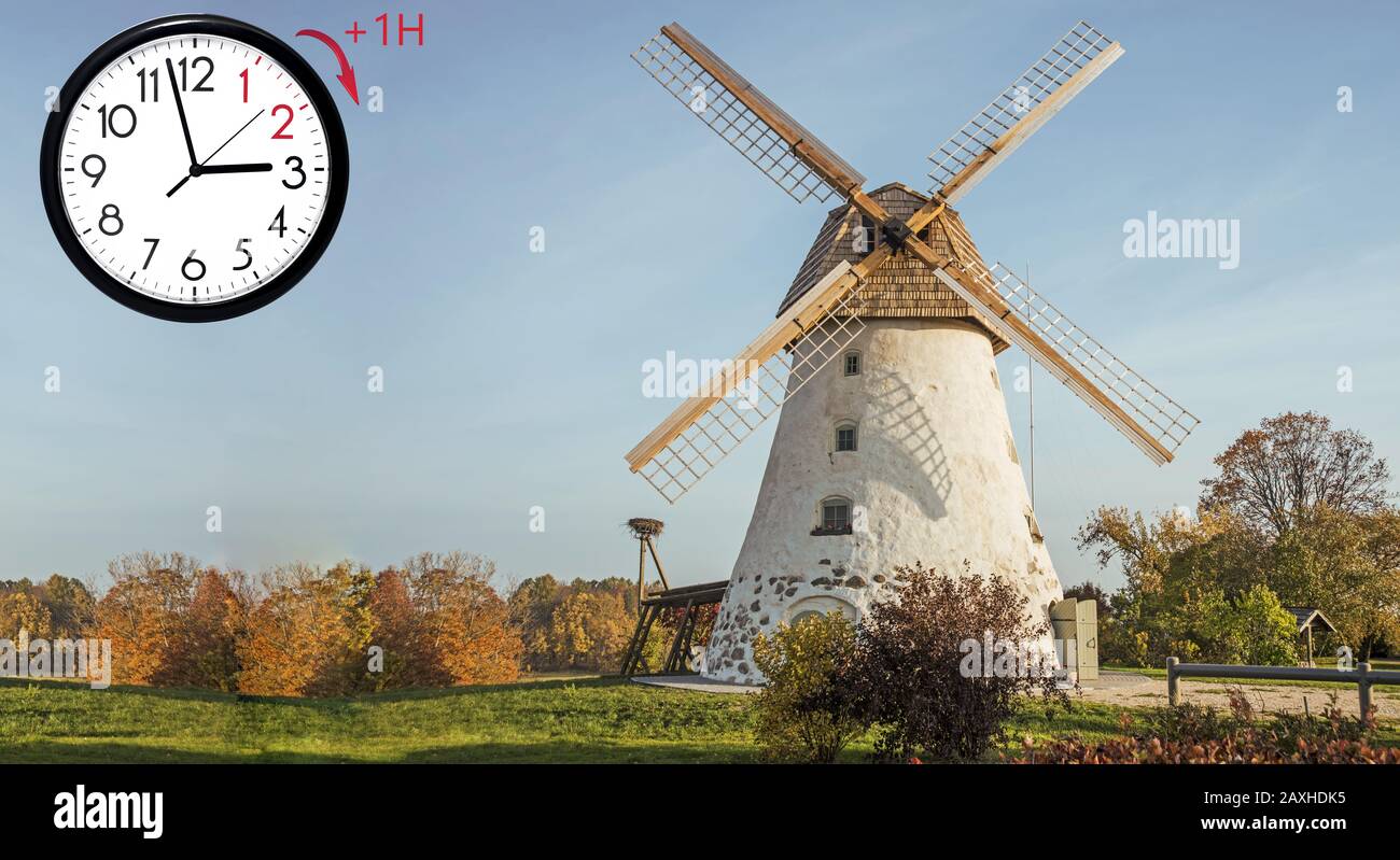 Daylight Saving Time (DST). Blue sky with white clouds and clock. Turn ...