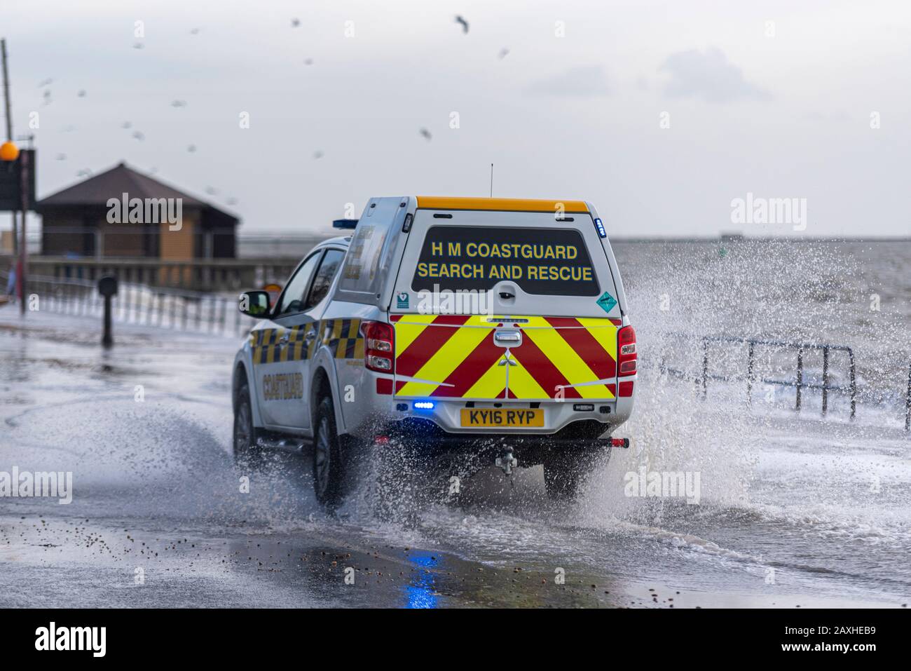 HM Coastguard car on emergency call driving through flooding during the ...