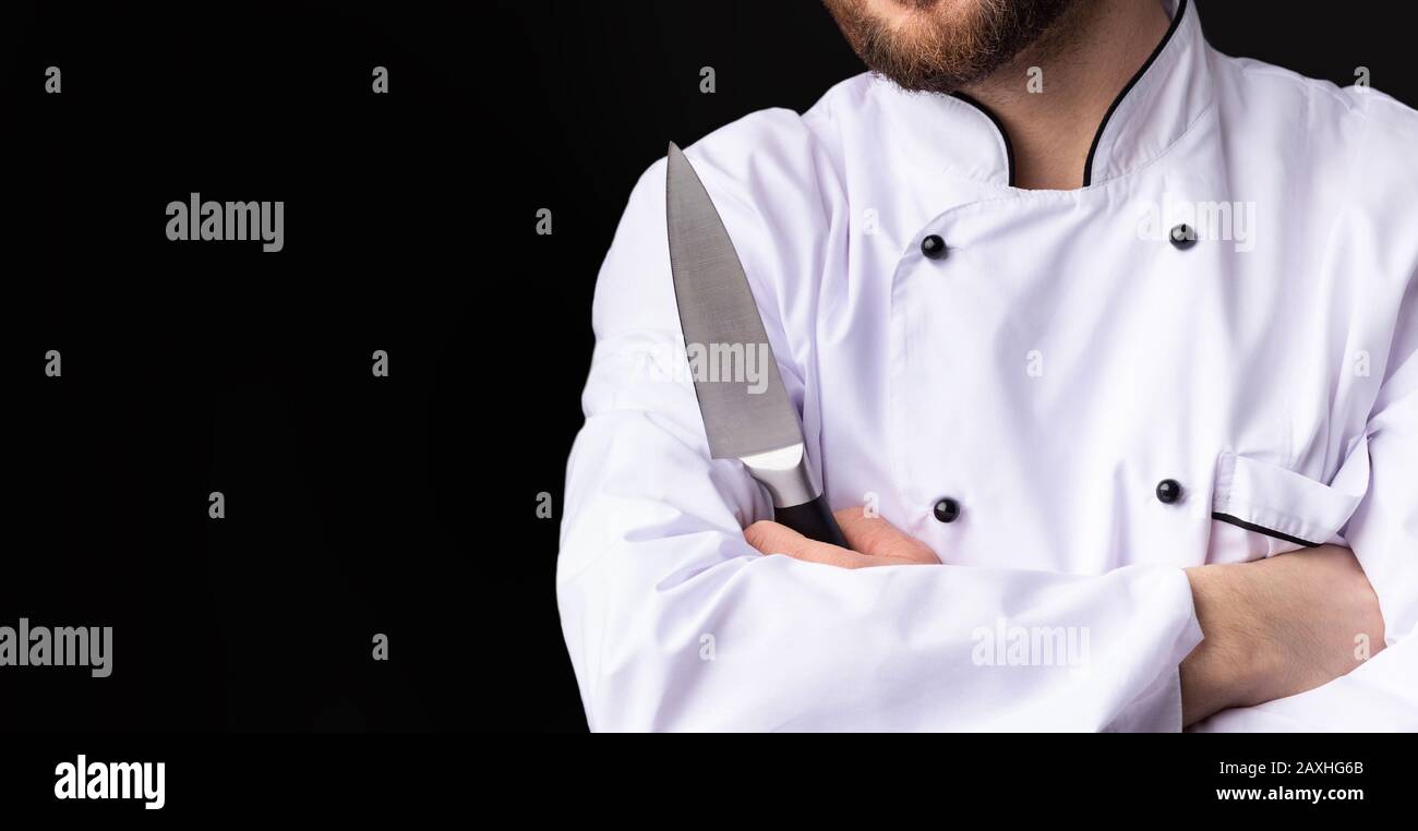 Unrecognizable Chef Holding Knife Standing On Black Background, Cropped ...