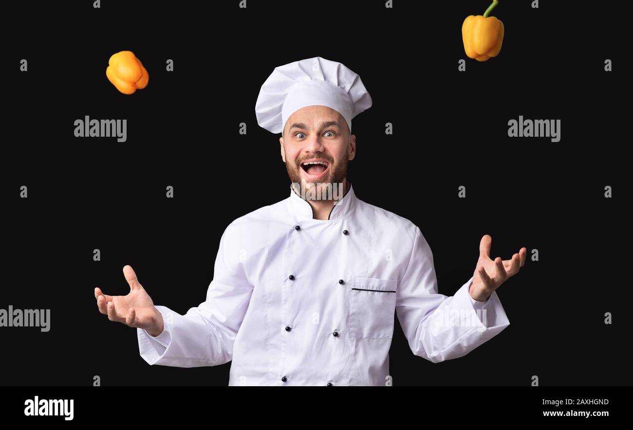 Excited Chef Guy Juggling Food Standing On Black Background Stock Photo ...