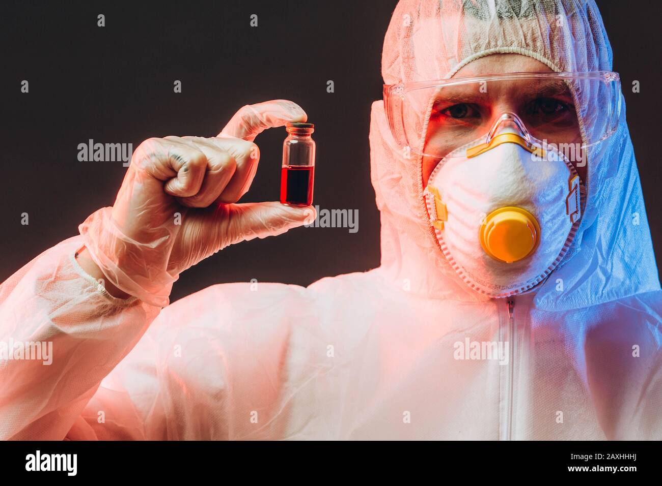 medical laboratory test tube and syringe with blood in the hand of a ...