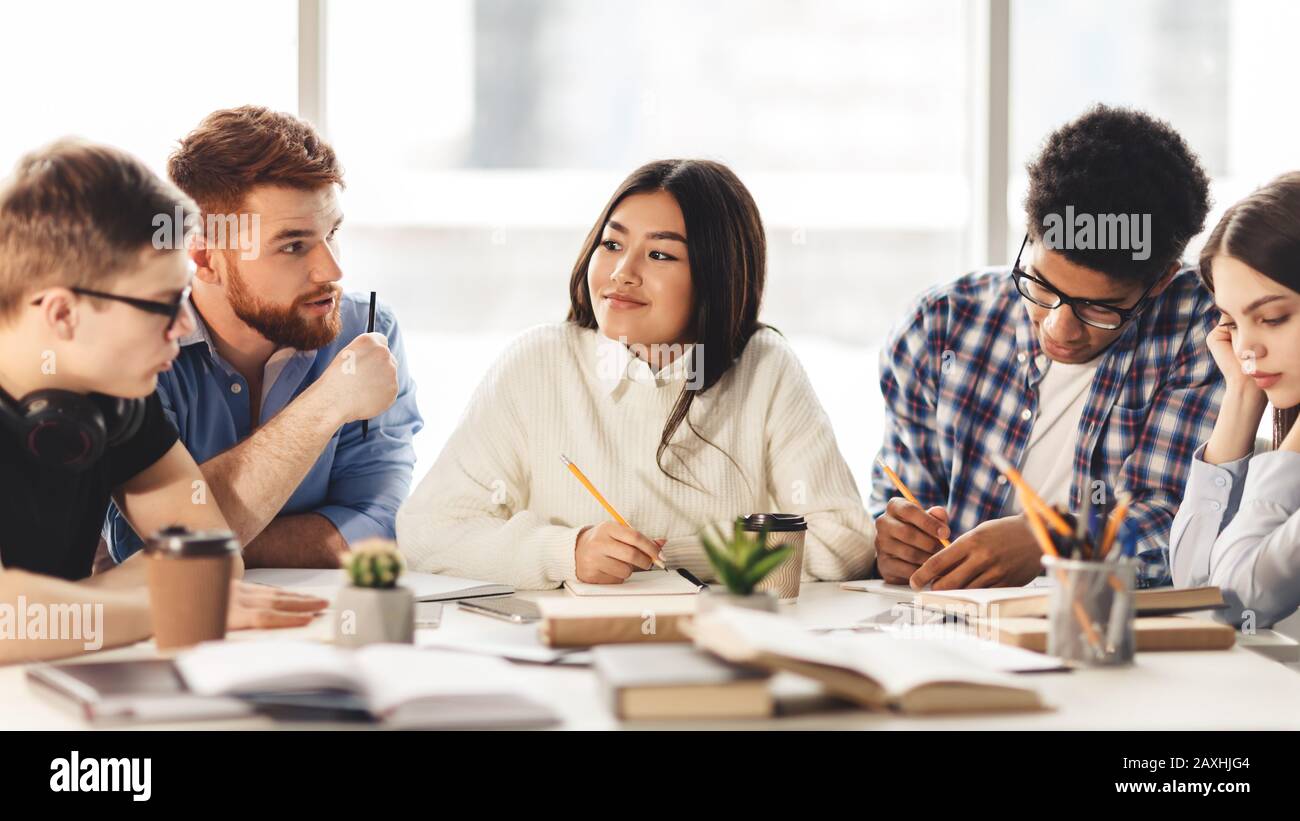 International college friends discussing homework at library together ...